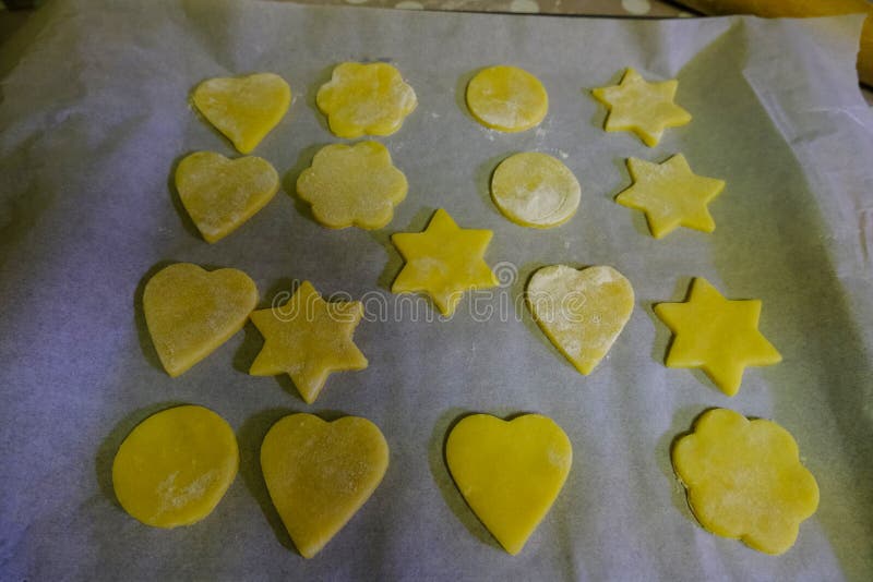 Biscuits Pastry of Different Shapes on Baking Paper on Baking Sheet ...