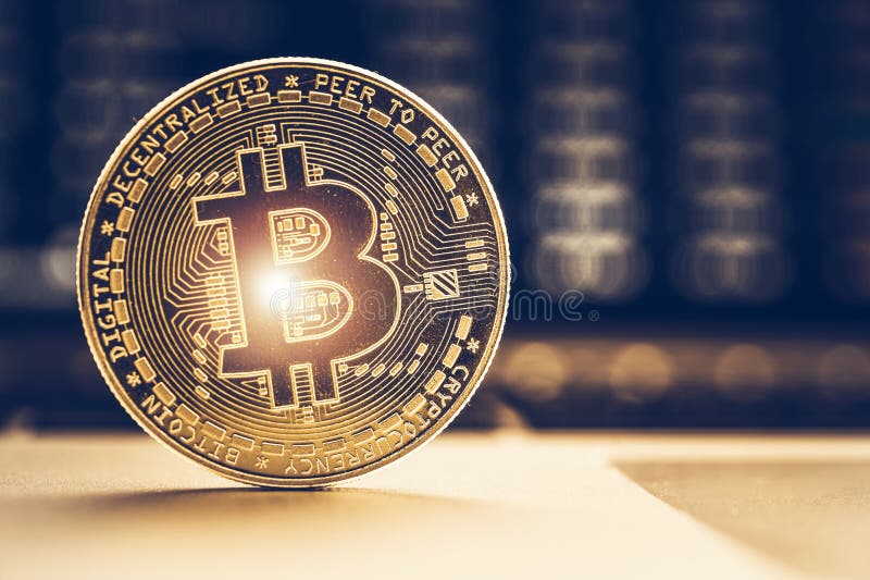 Bitcoin Coin Resting on a Table with Blurred Background of ...