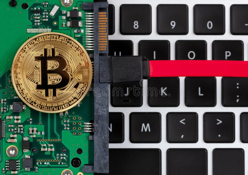 Bitcoin Currency on Mainboard of Computer with Keyboard in Background ...