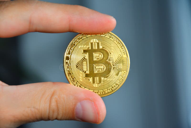 Bitcoin holding by man stock image. Image of exchange - 221942365
