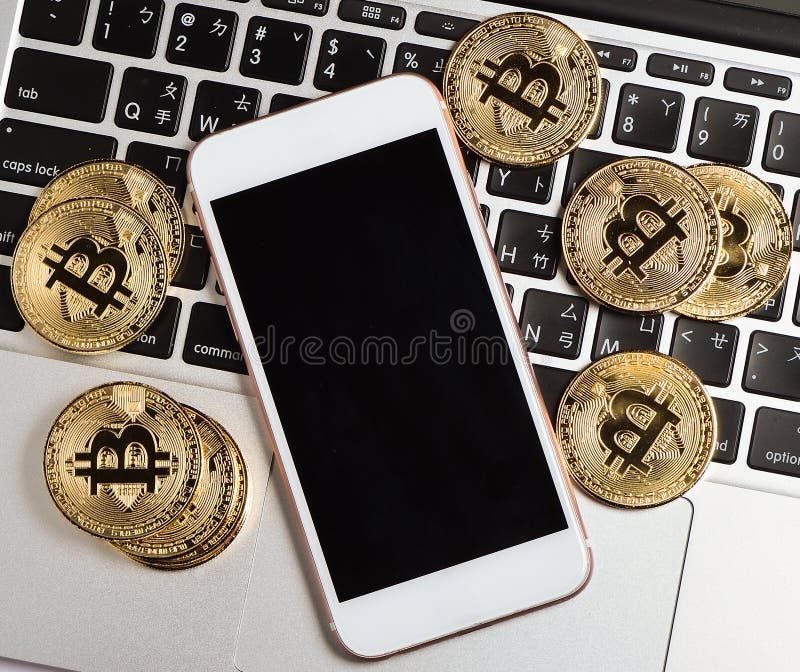 Bitcoin and Iphone on Laptop ,Bitcoin is a Crypto Currency Stock Image ...