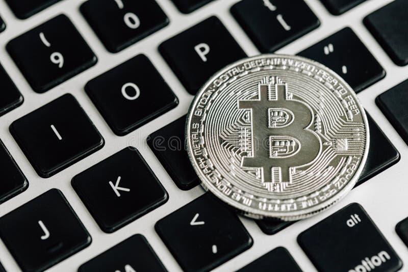 Bitcoin Silver Coin on Computer Laptop Keyboard. Virtual Cryptocurrency ...