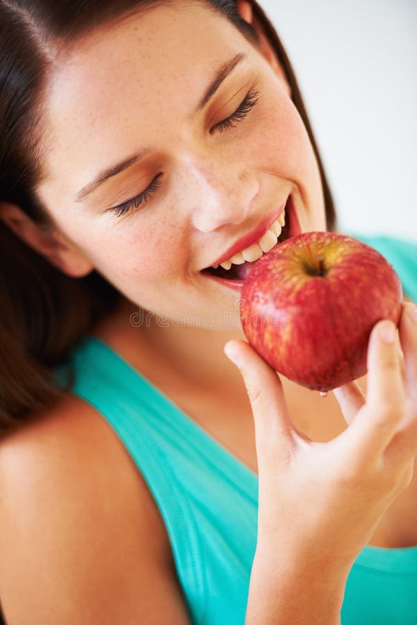 Biting into a Delicious Apple. an Attractive Young Woman Eating an Apple. Stock Photo - Image of ...