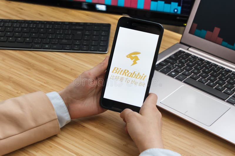 Bitrabbit Cryptocurrency Exchange Market. Female Trader Hands Holding the Smartphone Using ...