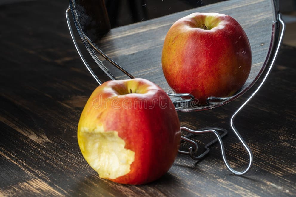 The Bitten Apple is Reflected in the Mirror Close Up Stock Photo ...