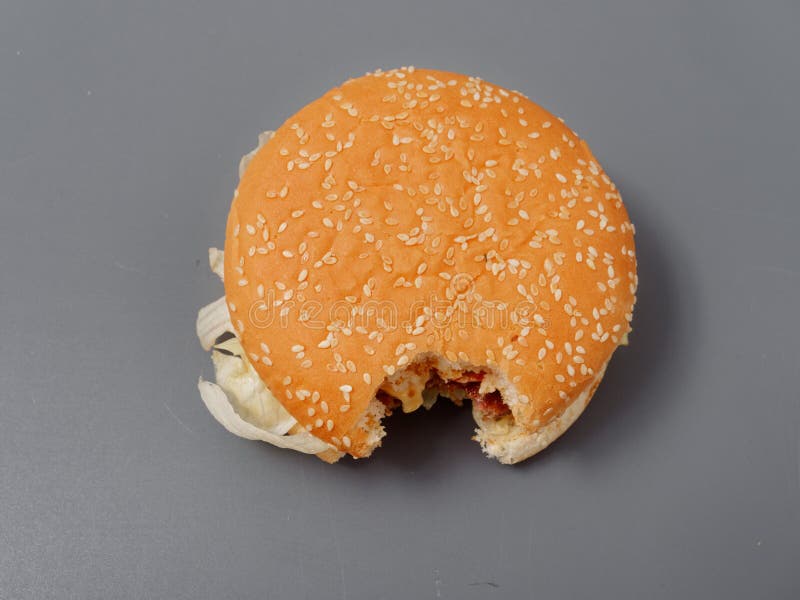 Bitten Big Burger with Cutlet Cheese and Tomato on a Gray Background ...