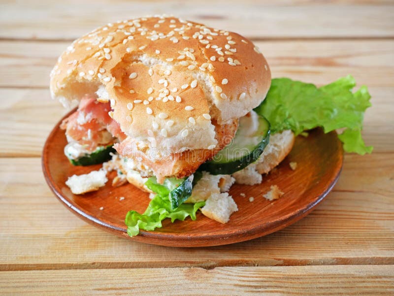 Bitten Burger with Beef, Tomato, Lettuce and Onion on Wooden Table ...