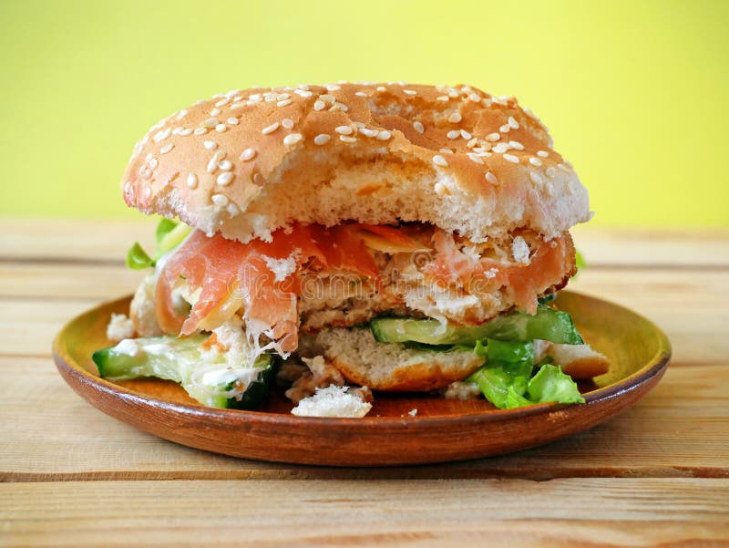 Bitten Burger with Beef, Tomato, Lettuce and Onion on Wooden Table ...