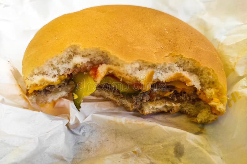 Bitten Cheeseburger with Cutlet and Cucumbers Close-up. Stock Photo ...