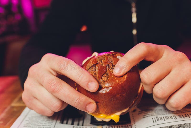 A Bitten Fresh Burger in the Hands of a Man. Stock Image - Image of ...