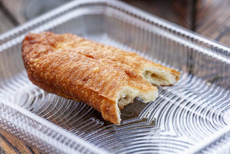 A Bitten Fried Pie in a Plastic Container. Close-up Stock Photo - Image ...