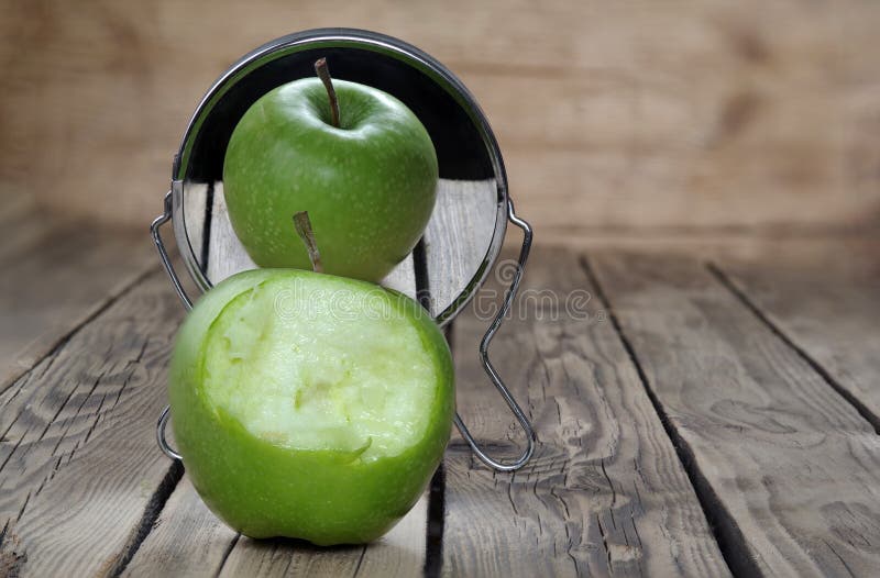 A Bitten Green Apple is Reflected with Its Beautiful Undamaged Side in ...