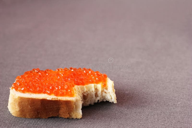 Bitten Off Sandwich with Red Caviar on a Gray Background Stock Image ...