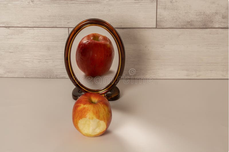 Bitten Red Apple Reflected in a Mirror Stock Photo - Image of ...