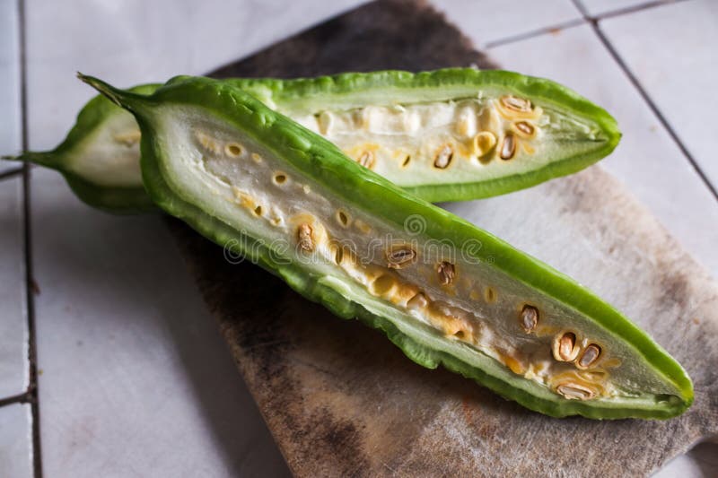 A Bitter Melon Vegetable Cut in Half on a Cutting Board Stock Photo ...