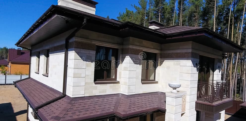 Bituminous Tile for a Roof. House with a Roof from a Bituminous Tile. a ...