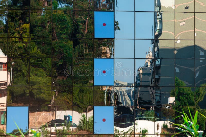 A Bizarre Distorted Reflection of a Residential Building and Trees in ...