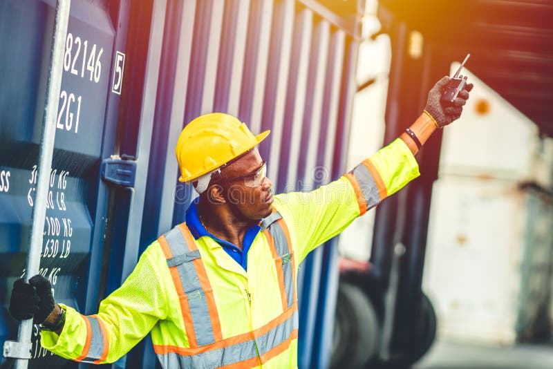 Black African Worker Working In Logistic Shipping Radio Control Order Command Loading Containers