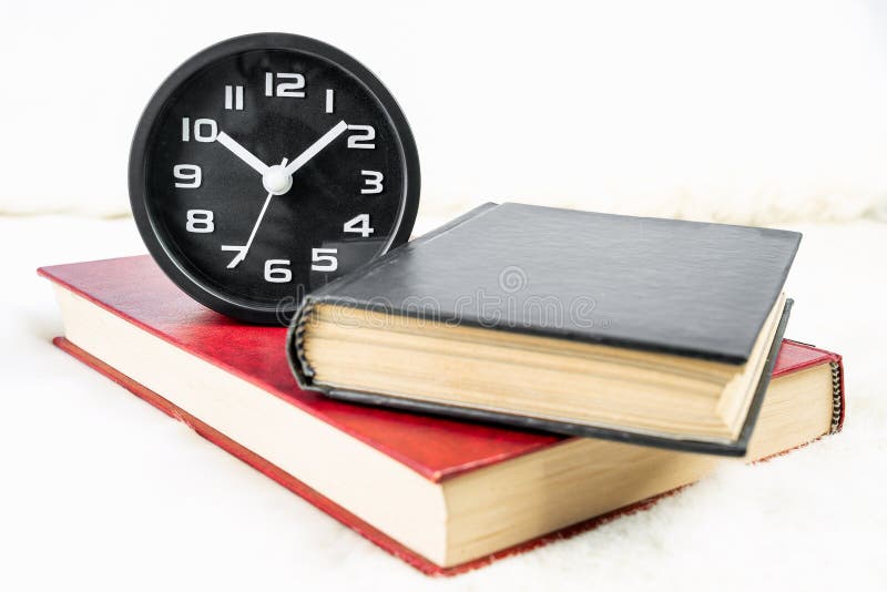 Black Alarm Clock and Book Stacked on Table Stock Photo - Image of wake ...
