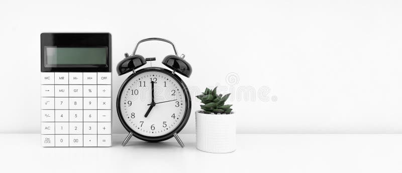 Black Alarm Clock with Calculator Against a White Wall. Financial ...