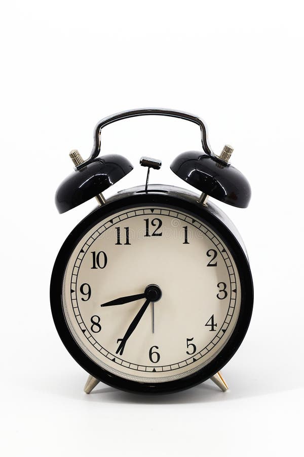 A Black Alarm Clock with Two Bells on Top, Chrome Handle, and Legs, Set ...