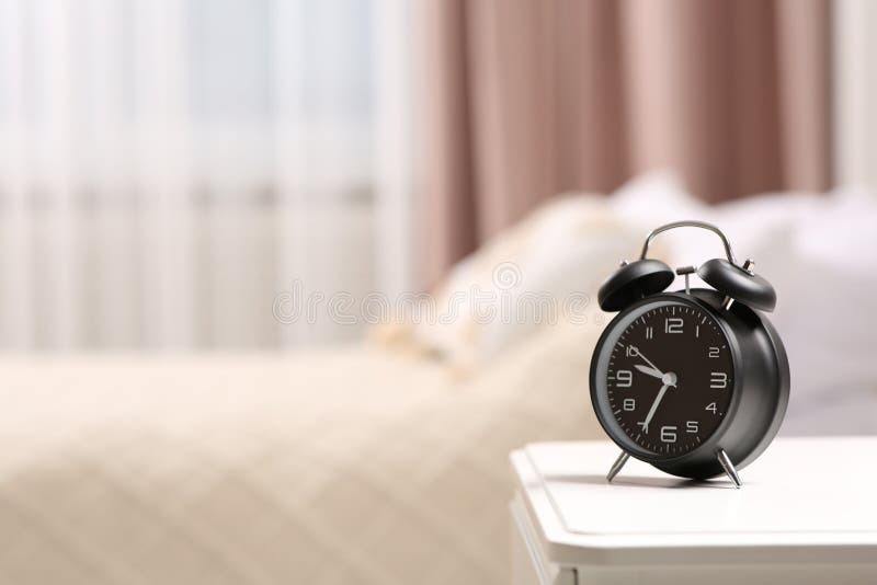 Black Alarm Clock on White Nightstand Indoors. Space for Text Stock ...