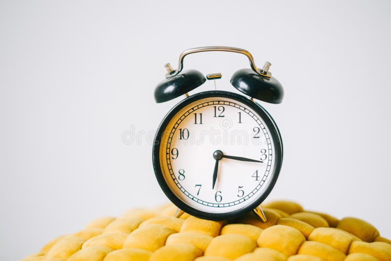 Black Alarm Clock on a Yellow Chair, Close Up Stock Photo - Image of ...