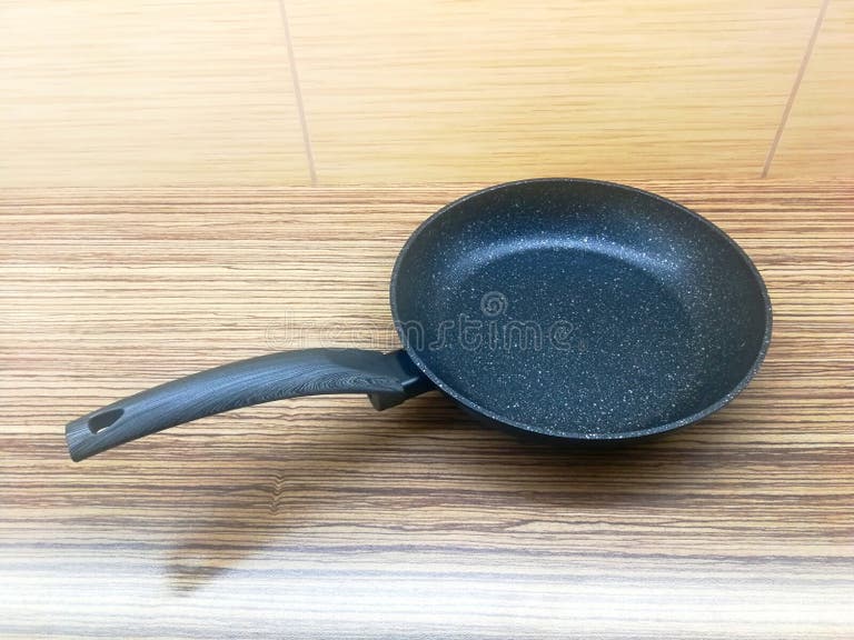 Black Aluminum Pan with Black Plastic Handle, Placed on the Kitchen ...