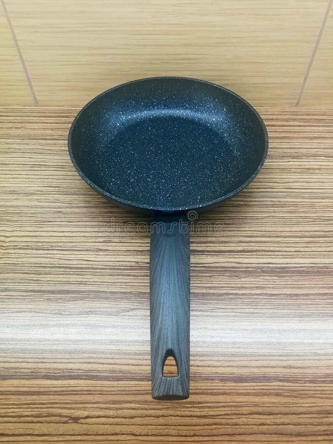 Black Aluminum Pan with Black Plastic Handle, Placed on the Kitchen ...