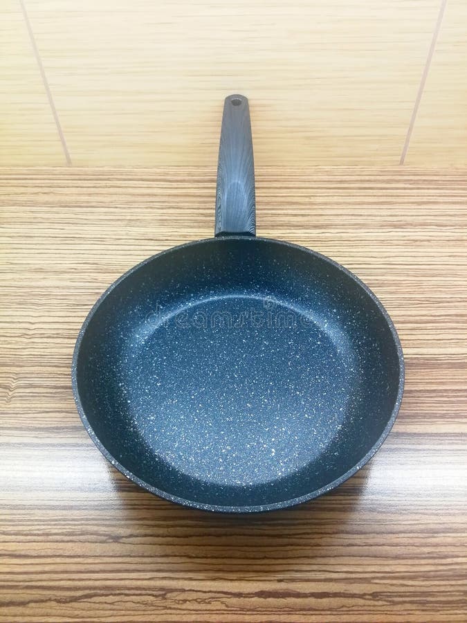Black Aluminum Pan with Black Plastic Handle, Placed on the Kitchen ...