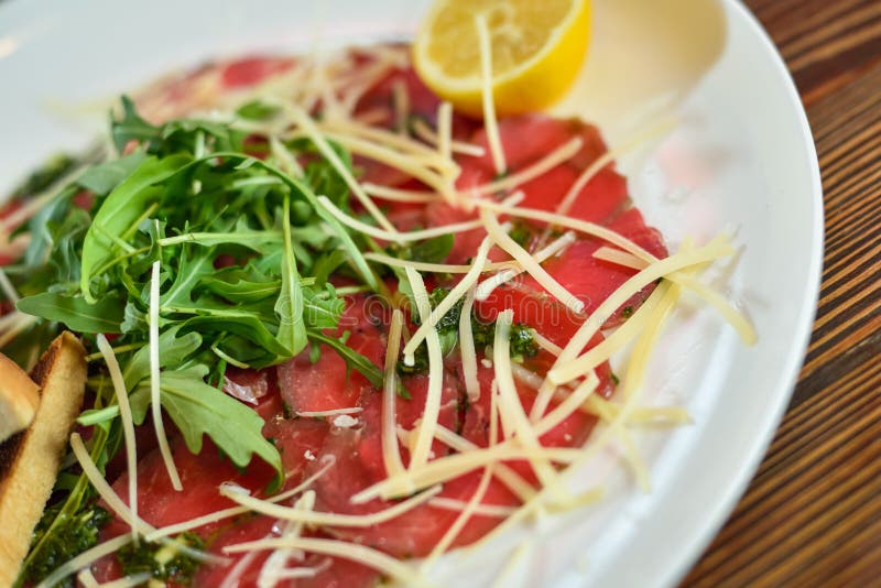 Black Angus Beef Carpaccio with Parmesan Cheese on a Plate Stock Photo ...