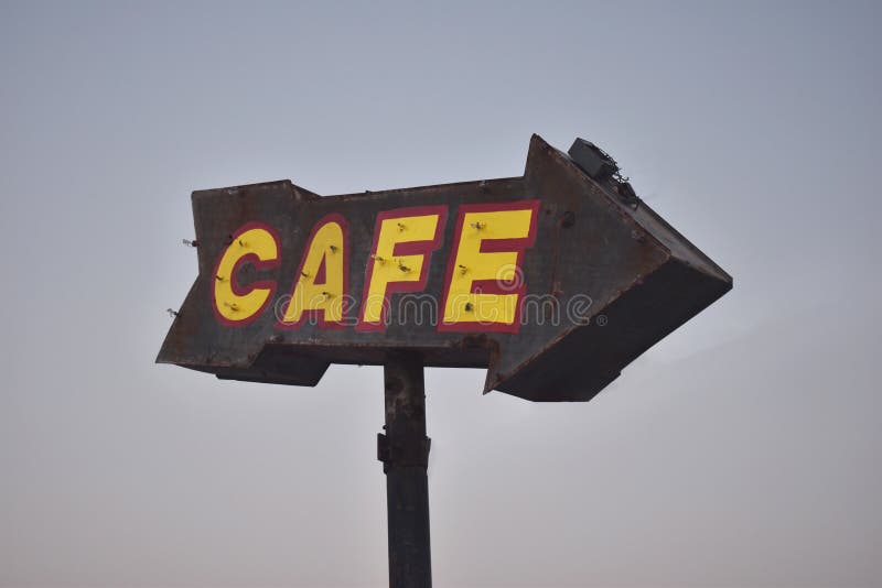Black Arrow Sign with Yellow Text Cafe on it Stock Photo - Image of ...
