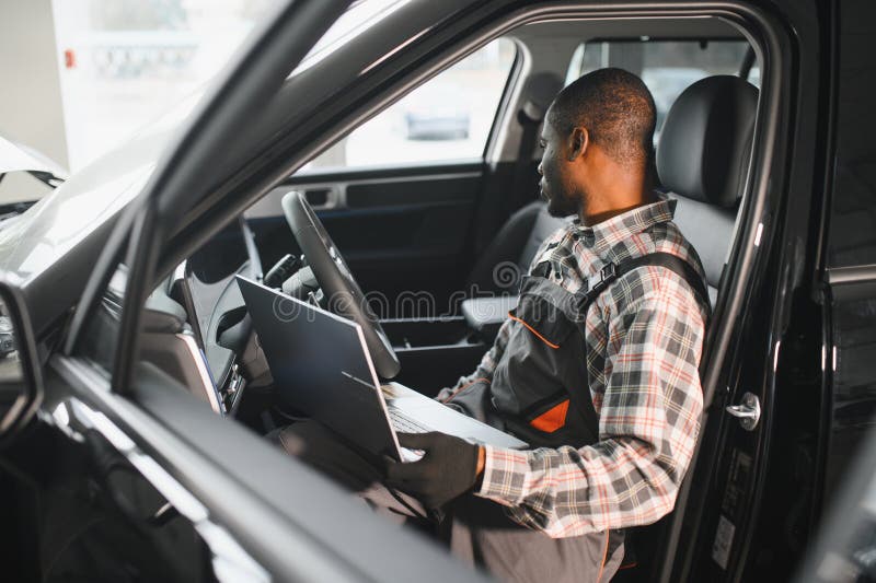 Black Auto Mechanic Running Diagnostic Laptop Analyzing Engine Problems ...