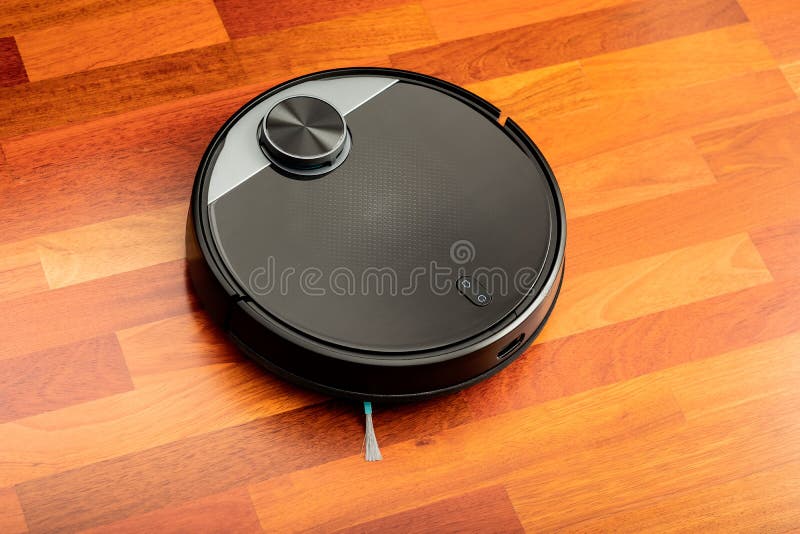 Black Automatic Vacuum Cleaner Robot in a House To Clean the Floor and ...