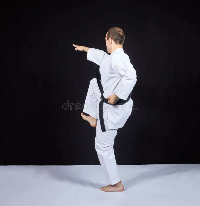 On a Black Background, a Karate Athlete Beats with a Knee Stock Photo ...