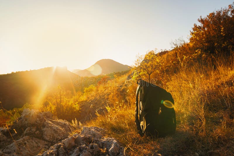 Black Backpack in the Mountains at Sunset Stock Photo - Image of ...