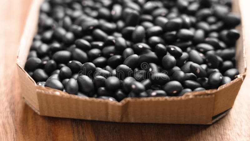 Black Beans Falling into a Cardboard Container in Slow Motion. Stock ...