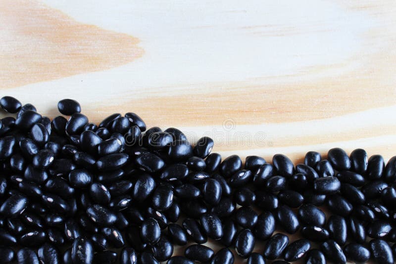 Black Beans. Portion of Black Beans in Lower Corner of Image on Wooden ...