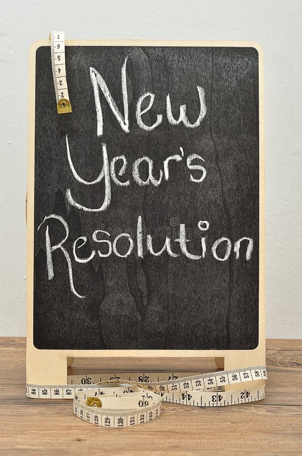 A Black Board with the Words New Years Resolution and a Measuring Tape ...