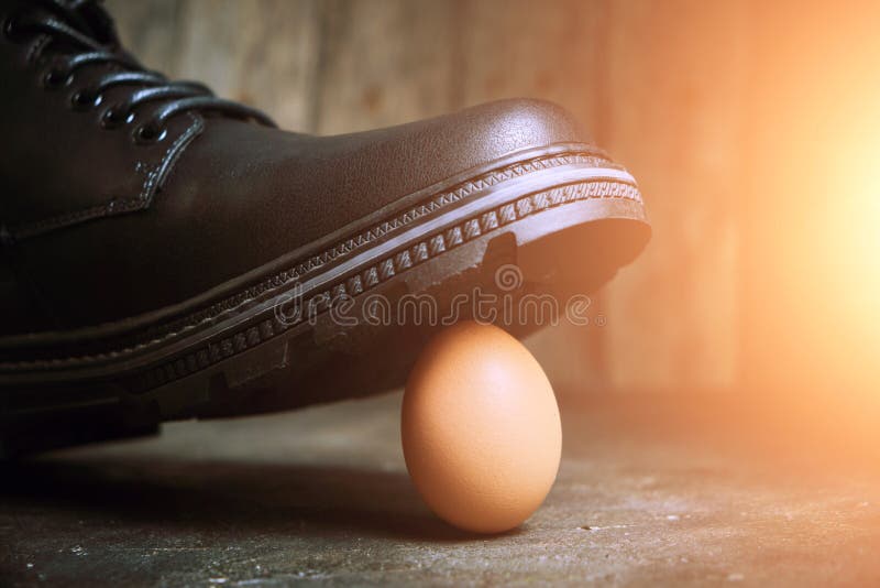 Black Boot and a Fragile Chicken Egg with a Sunny Glow Stock Photo ...