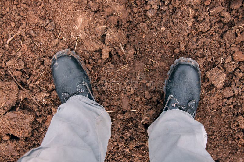 Black Boots on Clay Soil. Work Shoes Stock Photo - Image of closeup ...