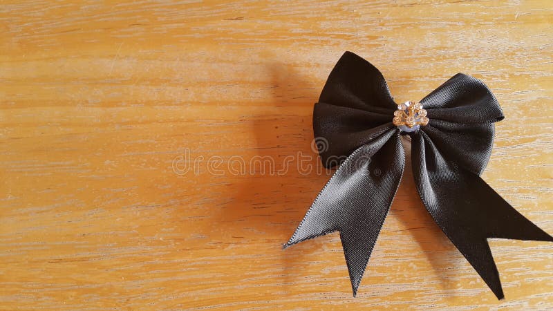Black Bow Closeup on the Wooden Screen. Stock Photo - Image of ...