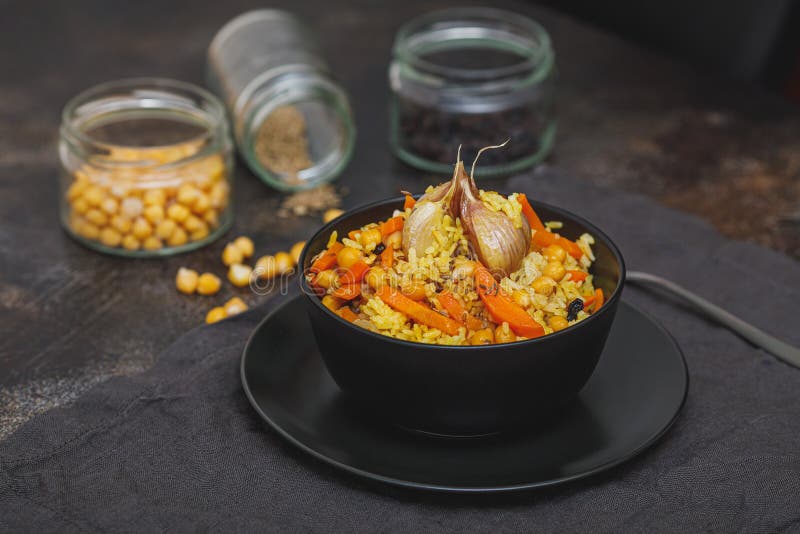 Black Bowl with Vegetarian Pilaf with Chickpea on Dark Background Stock ...