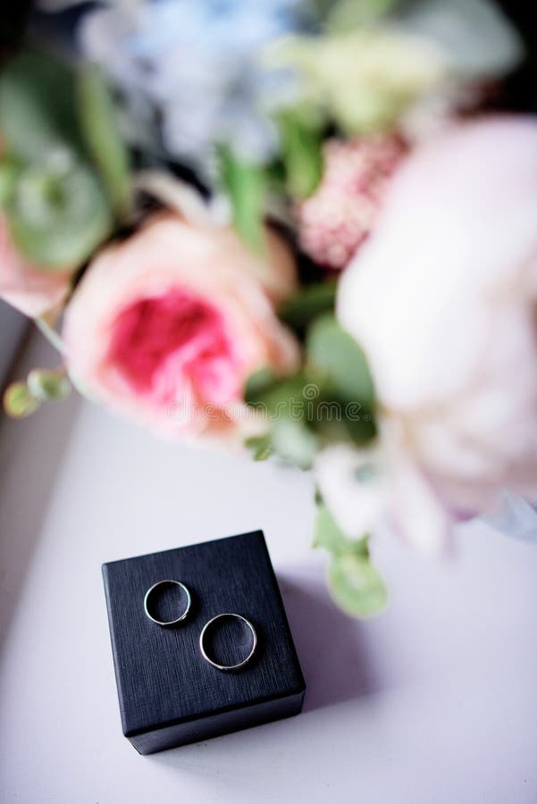 Black Box with Wedding Rings Stands Under a Pink Bouquet Stock Image ...