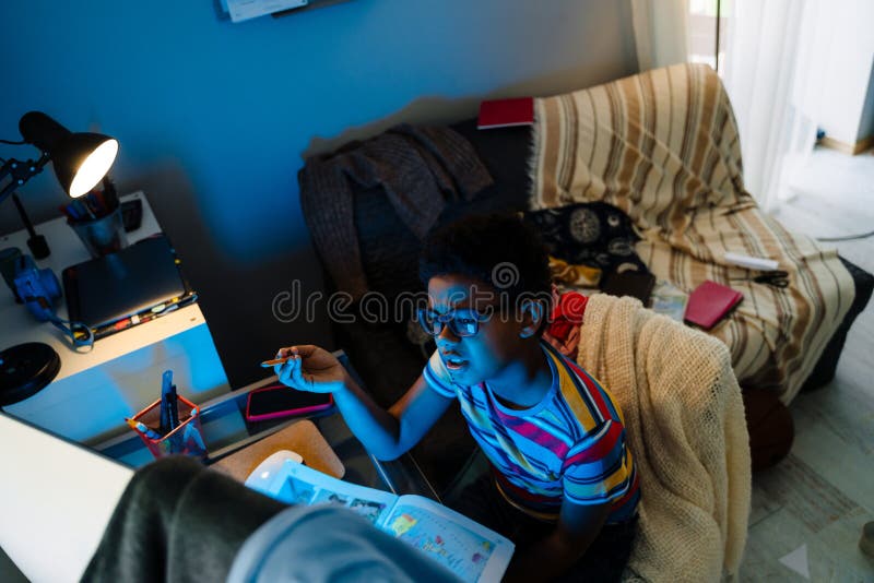 Black Boy Doing Homework with Computer while Sitting at Table Stock ...