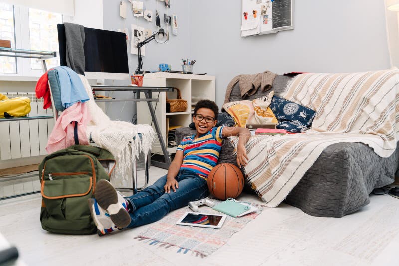 Black Boy in Eyeglasses Laughing while Sitting on Floor Stock Photo ...