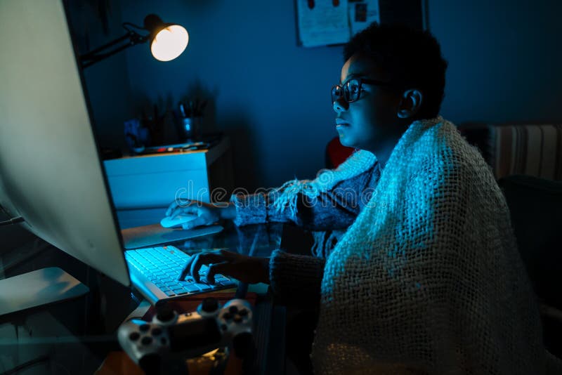 Black Boy Working with Computer while Sitting at Table at Home Stock ...