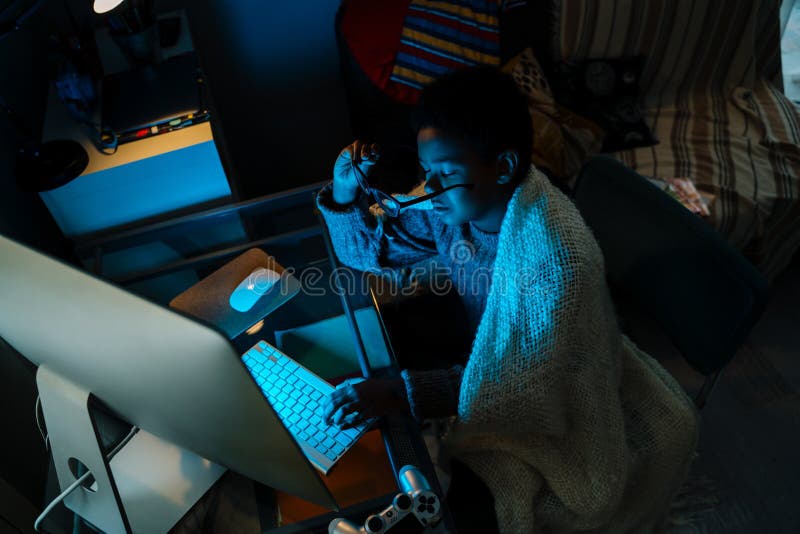 Black Boy Working with Computer while Sitting at Table at Home Stock ...