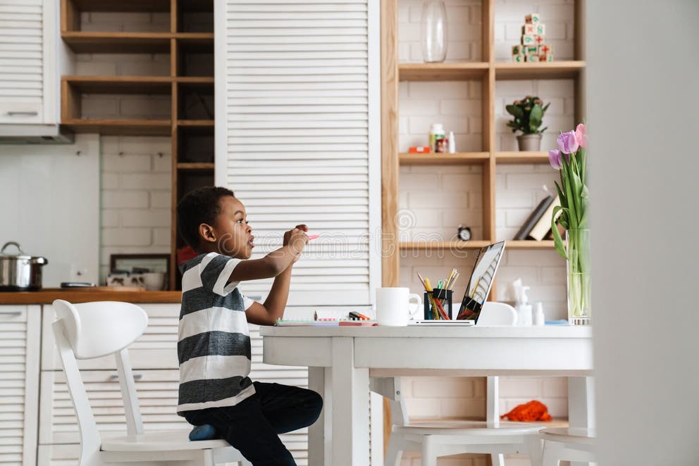 Black Boy Using Laptop and Drawing while Sitting Stock Image - Image of ...