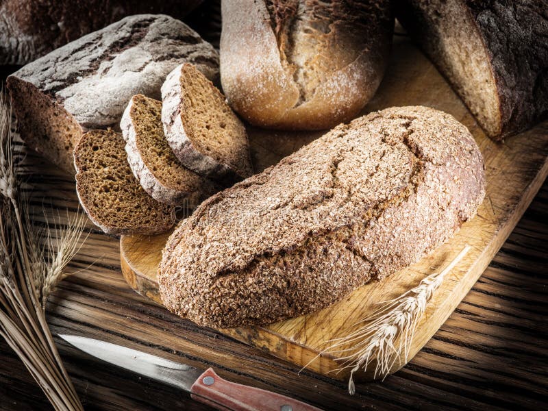 Black Bread Loafs on the Wooden Plank. Stock Image - Image of golden ...